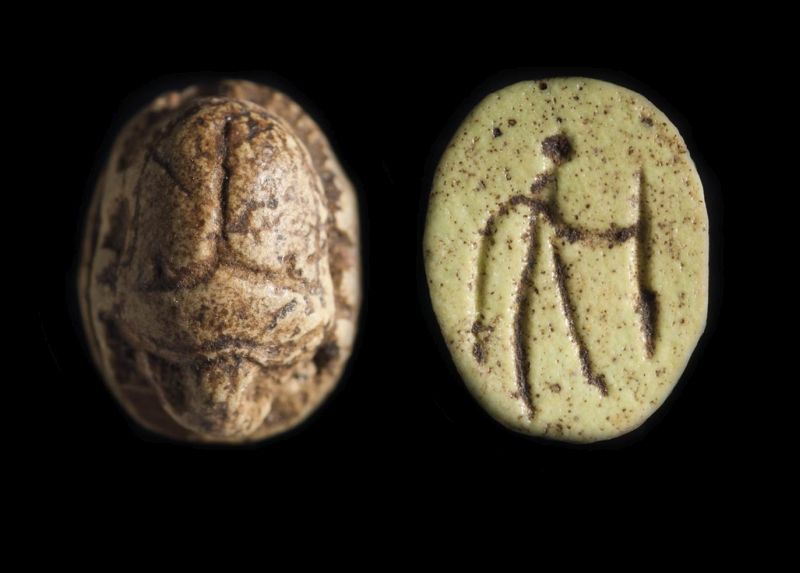 Scarab depicting a linear figure of a man holding a staff, possibly a ...