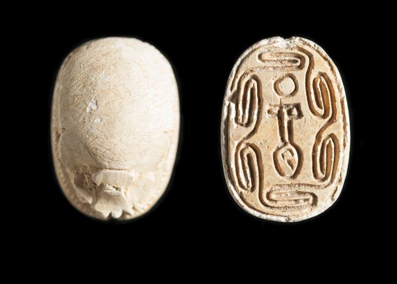 Scarab depicting the signs "nefer" "re" enclosed in a scroll border ...