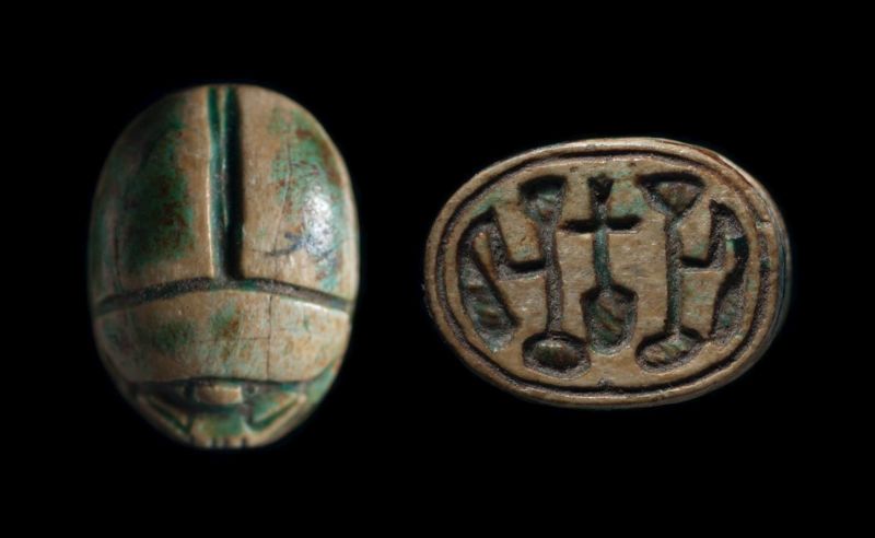 Scarab displaying a symmetric floral design flanking a "nefer" sign ...