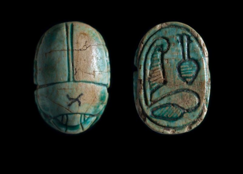 Scarab depicting a "Ma'at" feather attached to a floral bud, and "nefer ...
