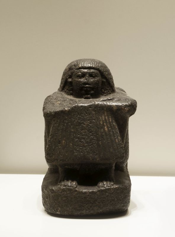 Block statue of an unknown official; block statues present the figure ...